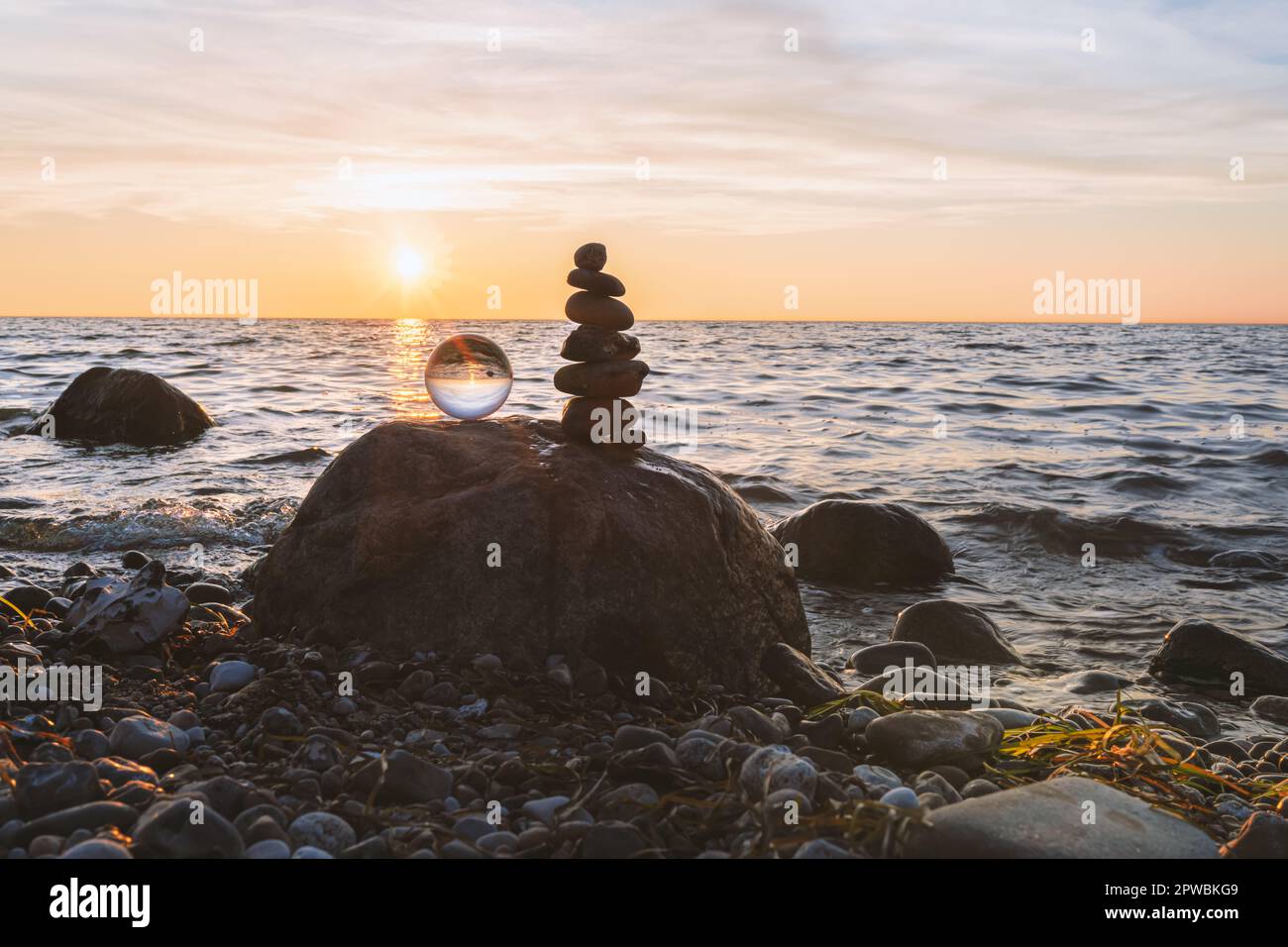 Stone pyramids and glass sphere on the dreamy Baltic Sea sand beach on ...