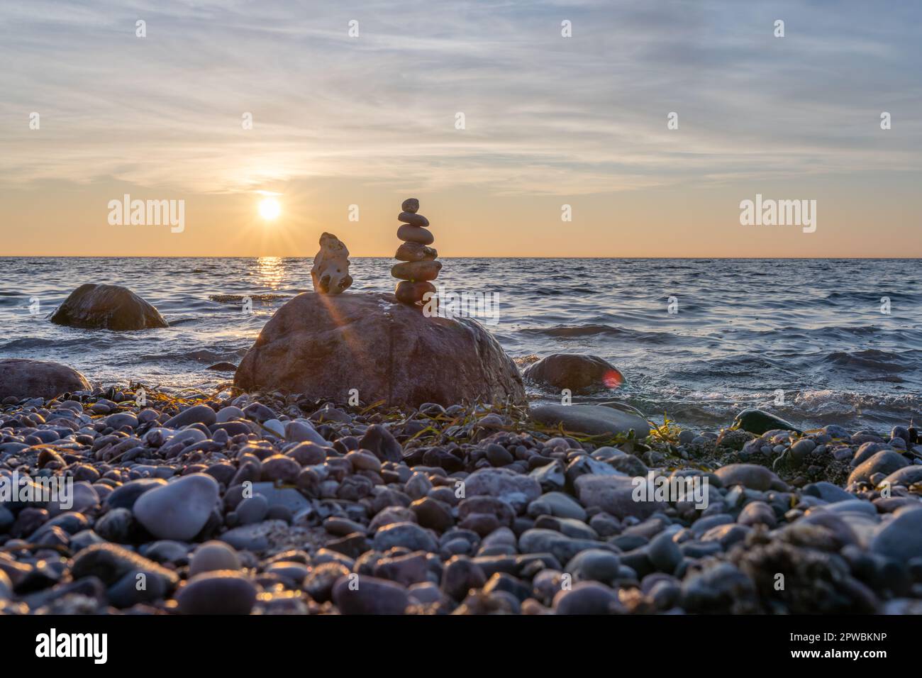 Stone pyramids and glass sphere on the dreamy Baltic Sea sand beach on ...
