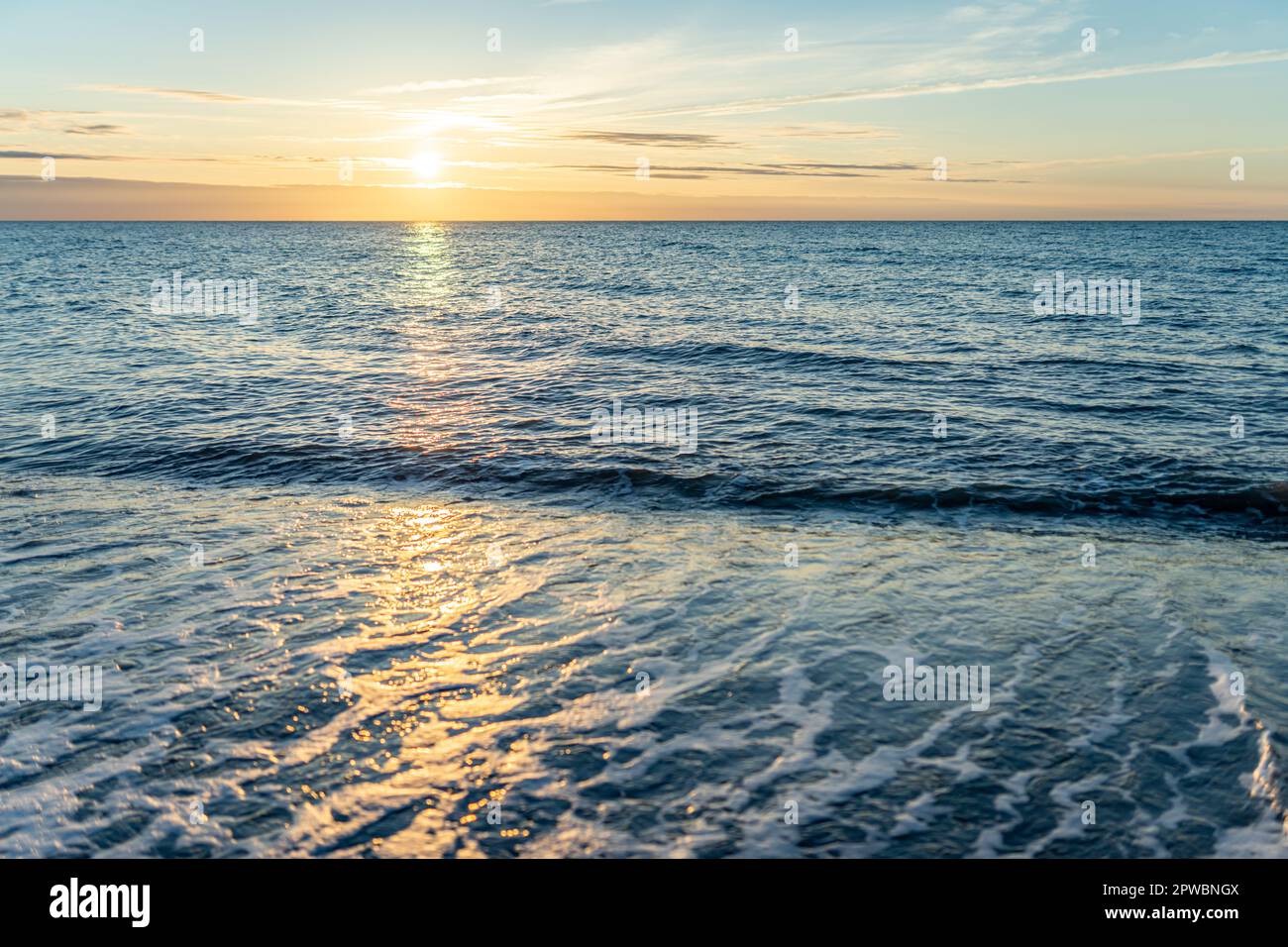 dreamlike, orange, sunset between rocks in the sea of the Baltic Sea ...