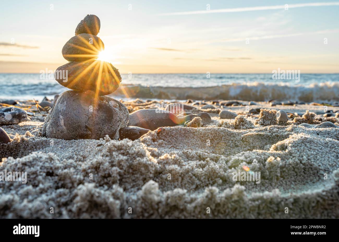 Stone pyramids and glass sphere on the dreamy Baltic Sea sand beach on ...