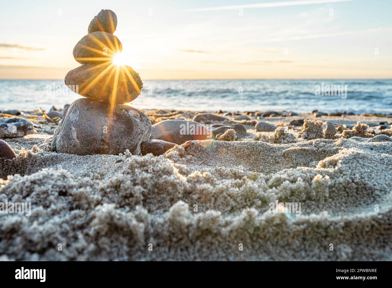 Stone pyramids and glass sphere on the dreamy Baltic Sea sand beach on ...