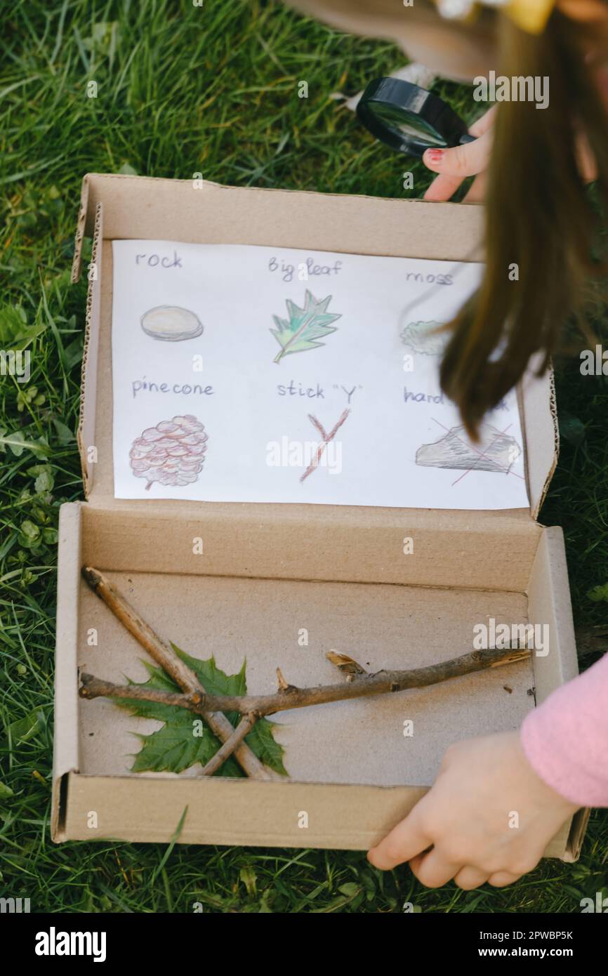 Scavenger hunt for kid in the park. Girl learning about environment ...