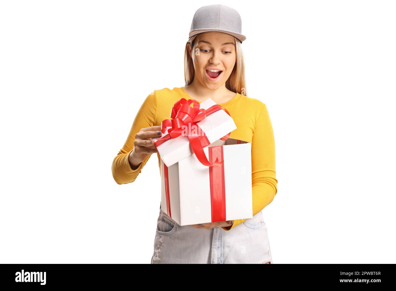 Exctied young woman opening a present box isolated on white background ...