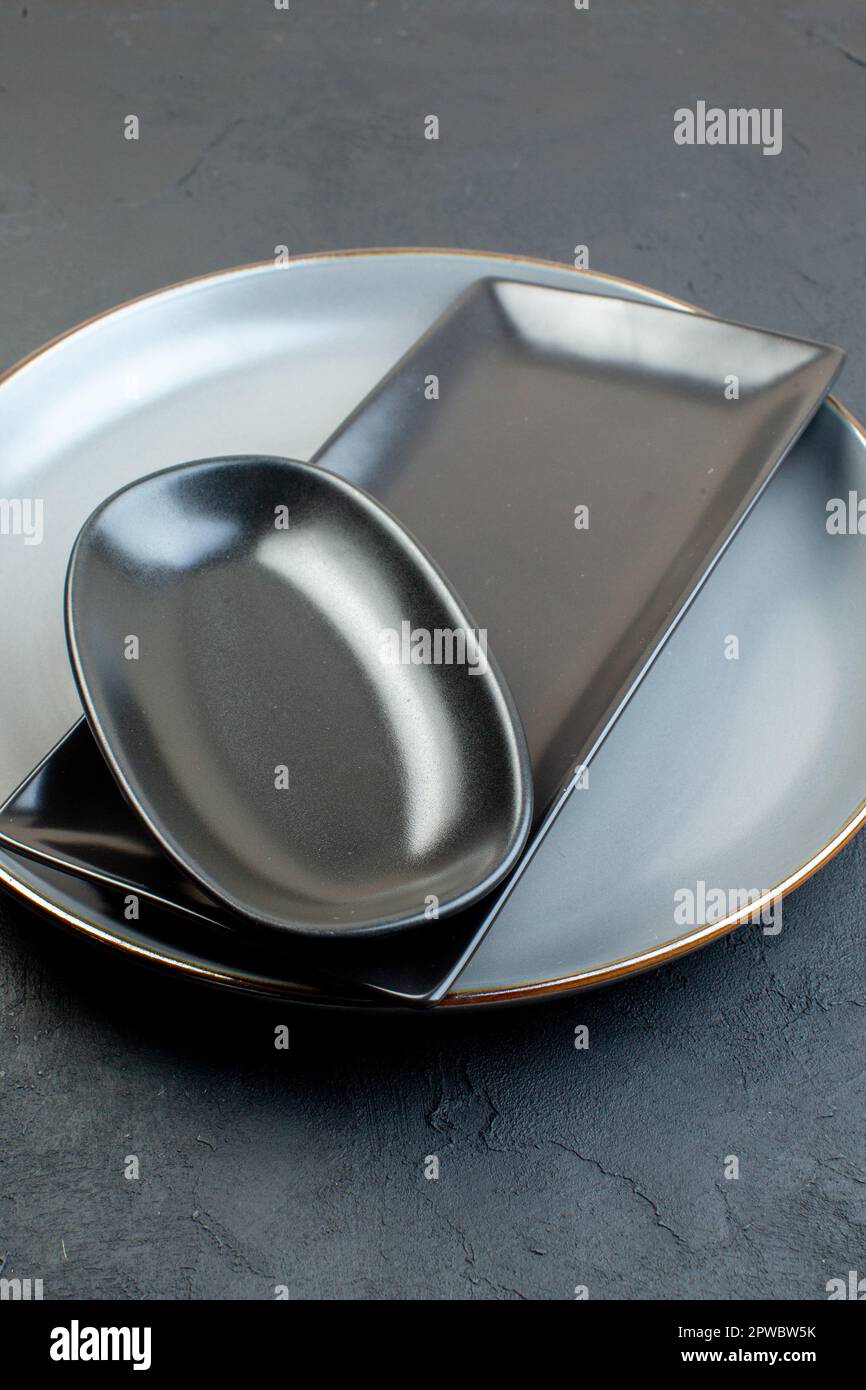 front view different elegant plates on dark background silverware ...