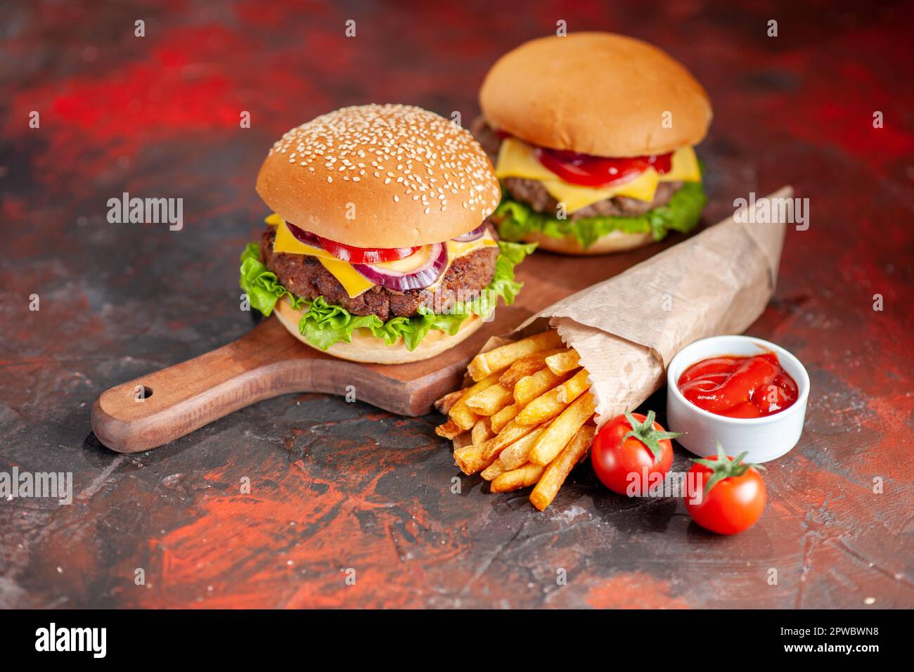 front view yummy french fries with cheeseburgers on dark background ...