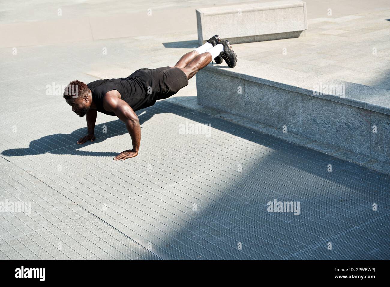 Fit sporty young black man doing push ups exercise in urban park Stock ...