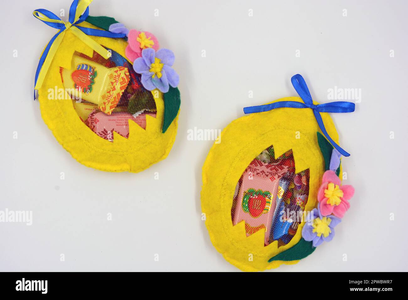Colored yellow packages with sweets packed in the form of an egg made ...