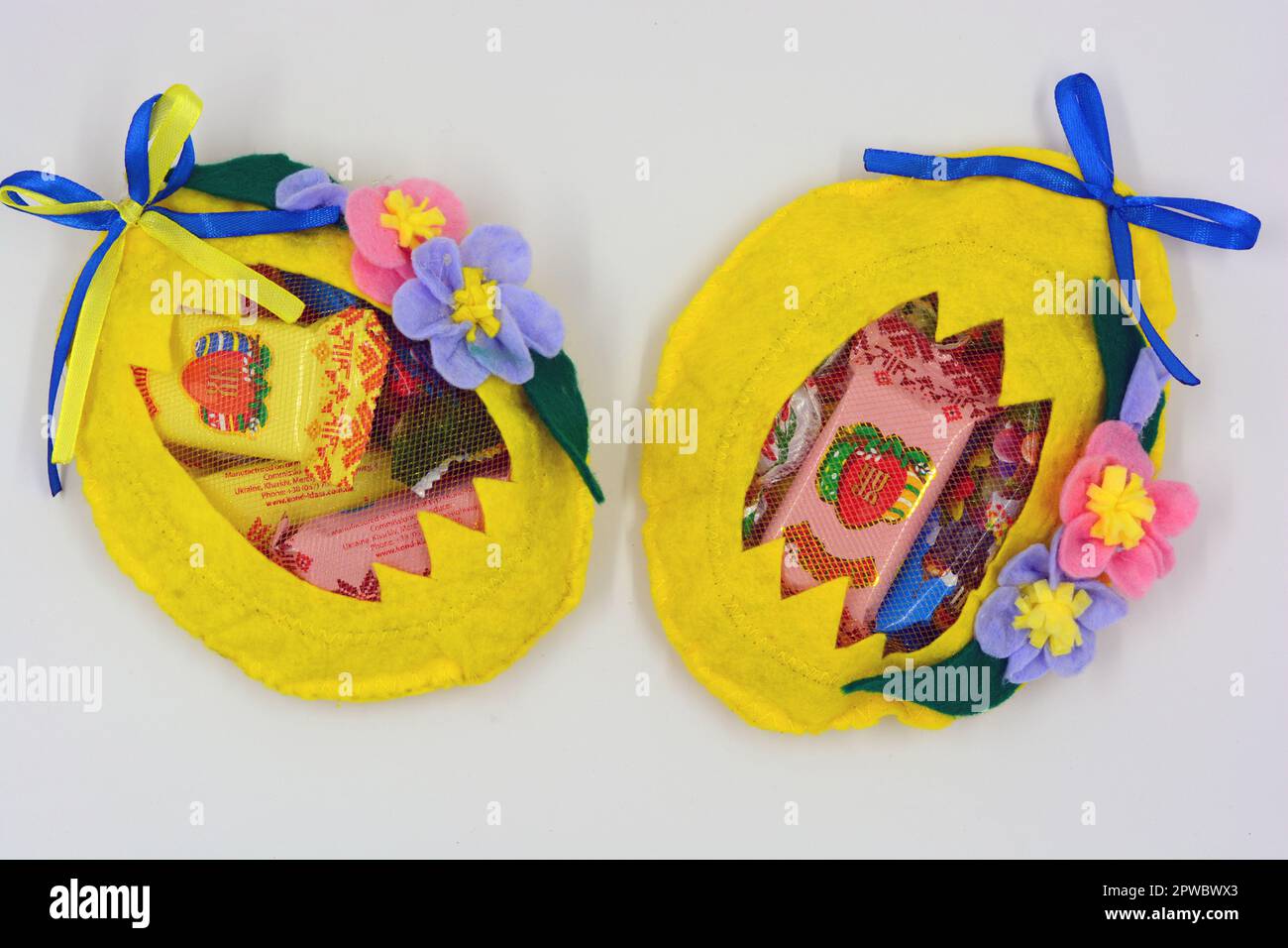 Colored yellow packages with sweets packed in the form of an egg made ...