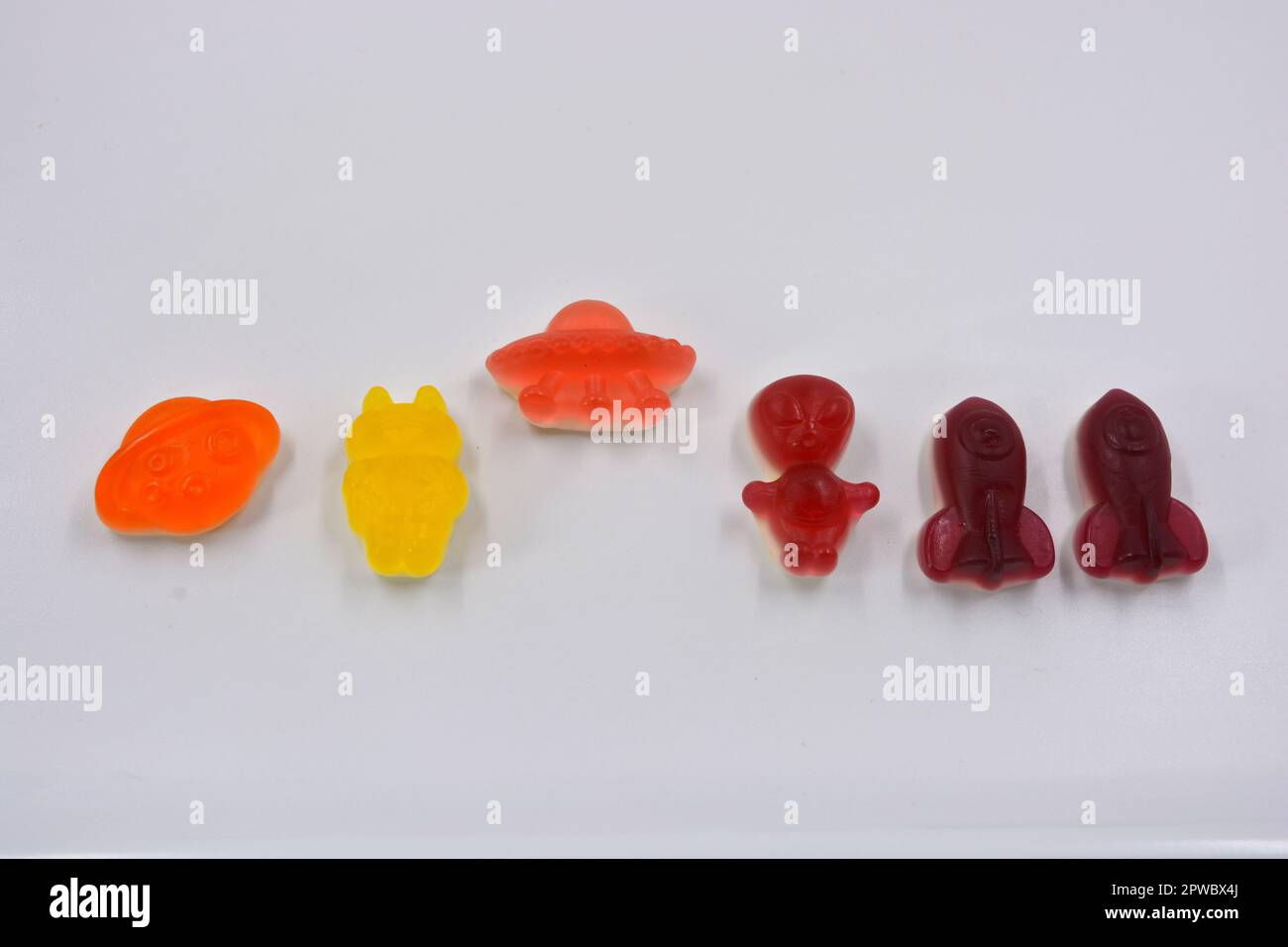 Sweets in the form of red, yellow aliens, cherry space rockets, green ...