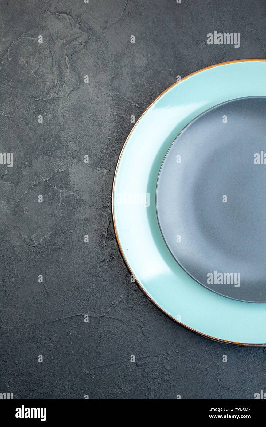 top view blue plate with gray plate on dark background silverware diner ...
