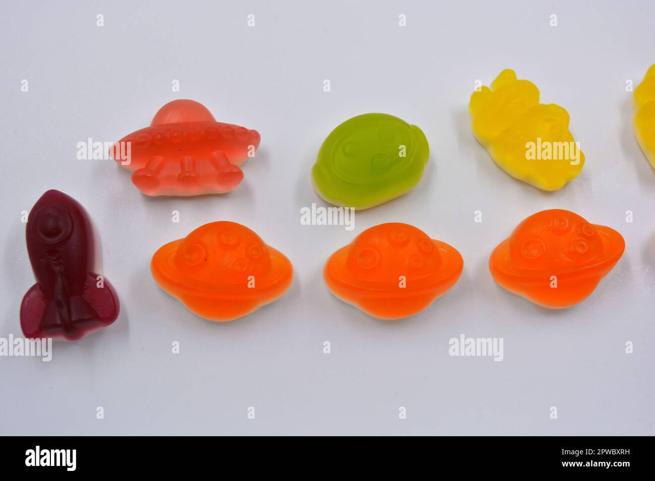 Sweets in the form of red, yellow aliens, cherry space rockets, green ...