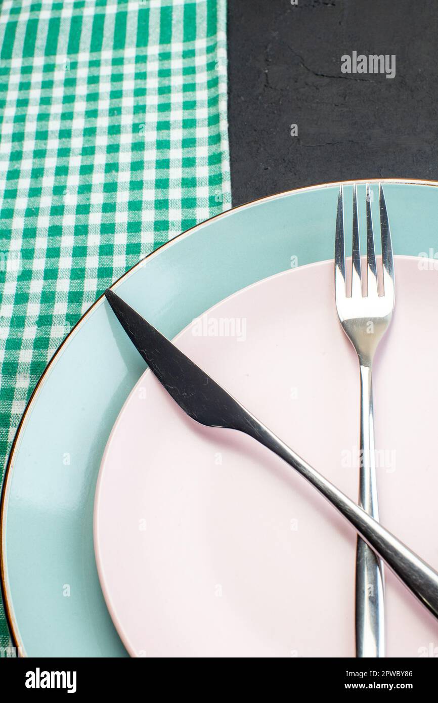 top view elegant pink plate with blue plate fork and knife dark ...