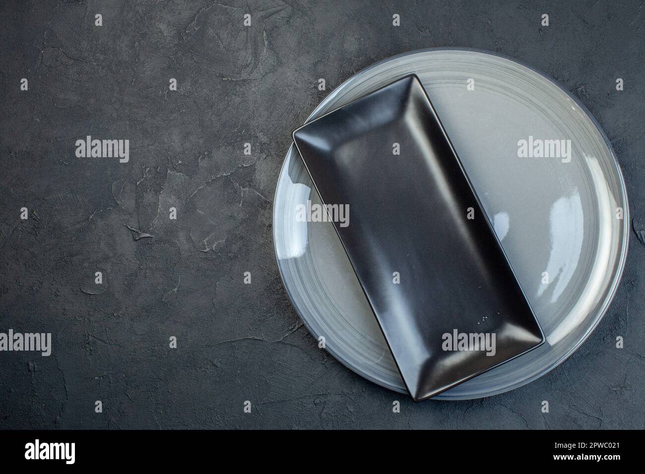 top view long black plate in gray plate on dark background glass food ...