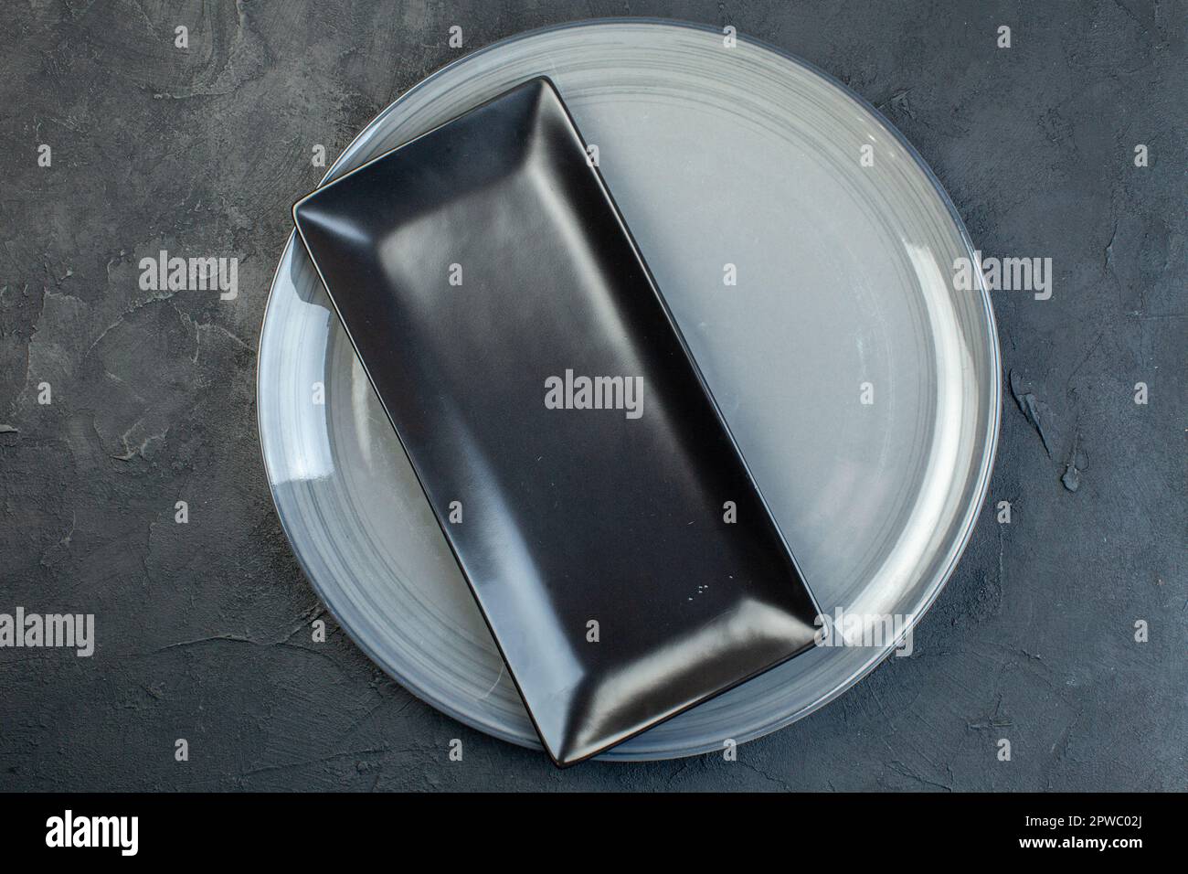 top view long black plate in gray plate on dark background glass ...