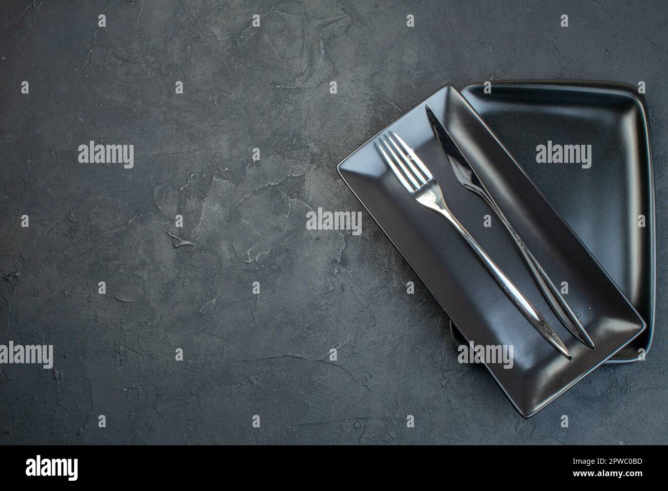 top view long black plates on dark background glass horizontal ...