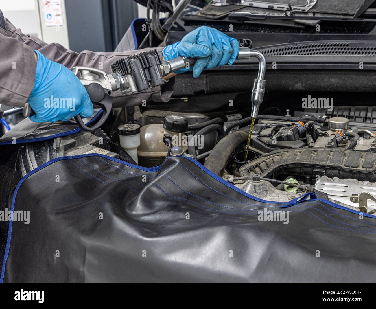 Engine oil filling in the car service. Maintenance in a car service ...