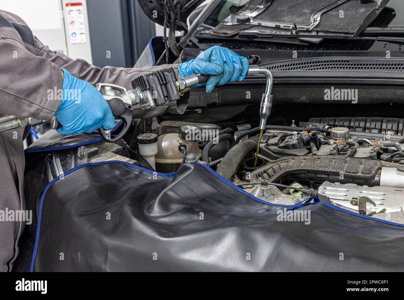 Engine oil filling in the car service. Maintenance in a car service ...