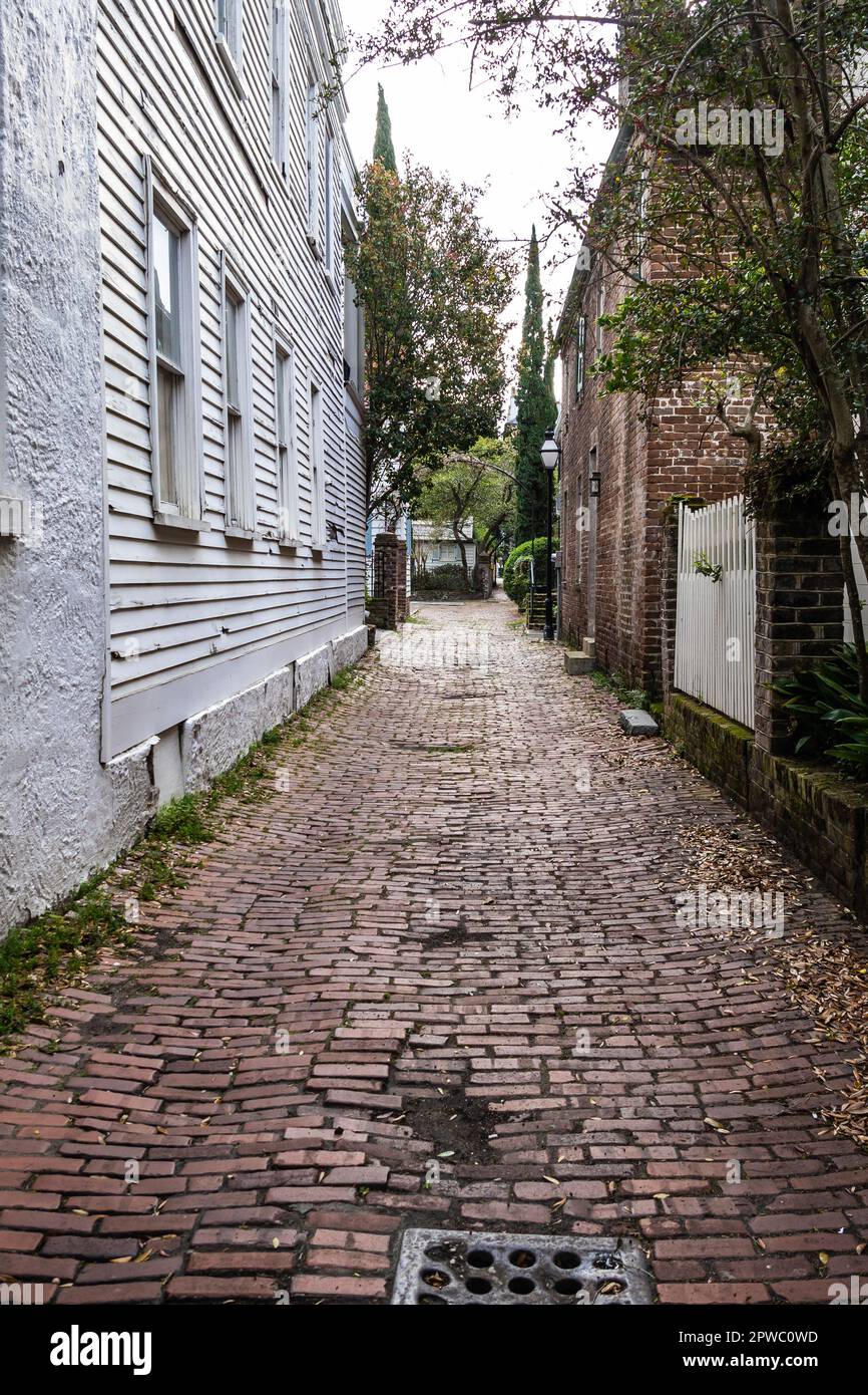 Looking down an alley with a brick surface and ambient light from the ...