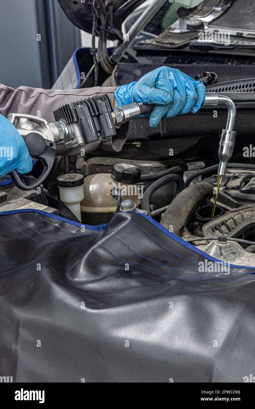 Engine oil filling in the car service. Maintenance in a car service ...