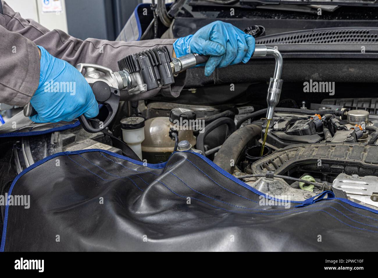 Engine oil filling in the car service. Maintenance in a car service ...