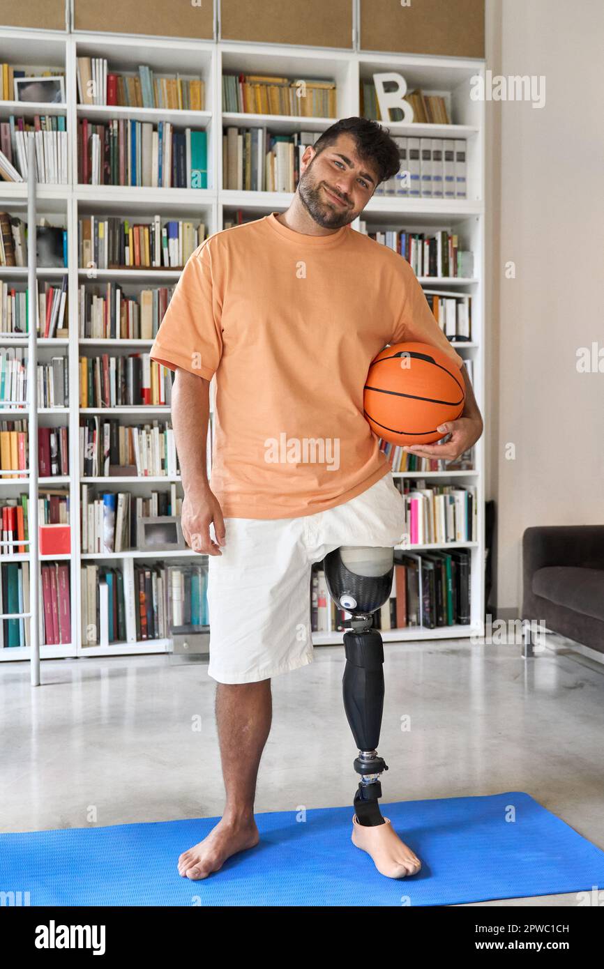 Amputee man with prosthetic leg prosthesis posing with basketball ball ...