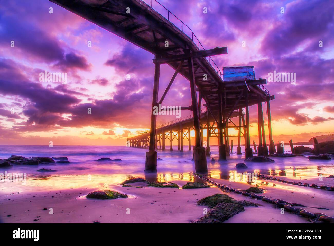 Colourful pink sunrise at Catherine Hill bay middle camp beach under ...
