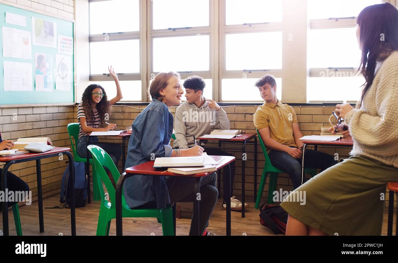 Yes you have a question. a cheerful young teacher giving class to a ...