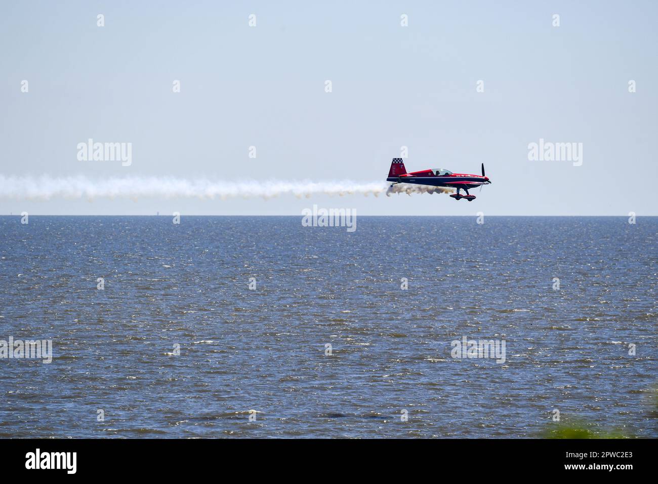 An EXTRA 300S flies over Biloxi Beach during a practice session for the ...