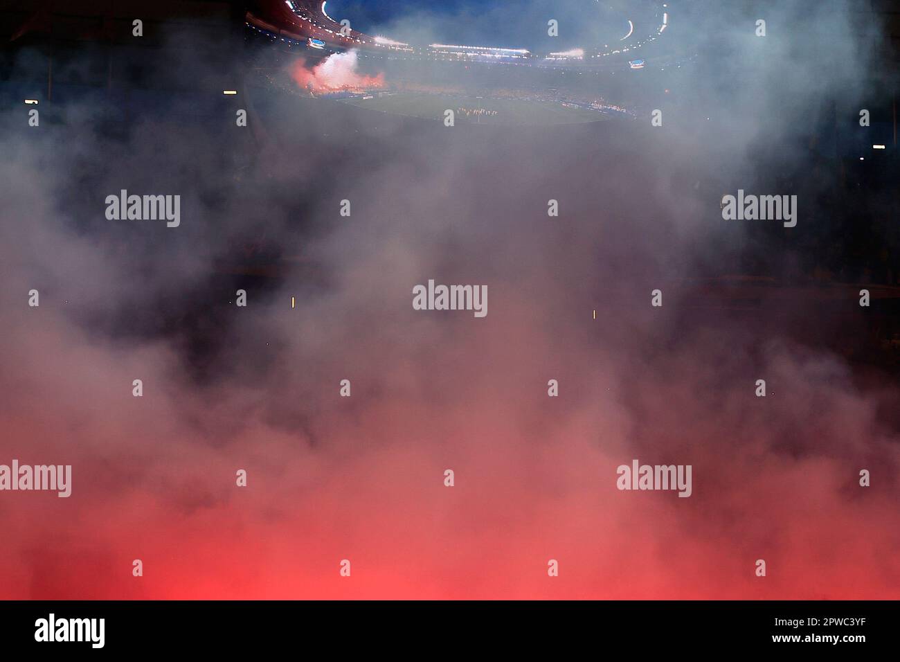The stadium is shown on a screen shrouded in smoke as Nantes fans light ...