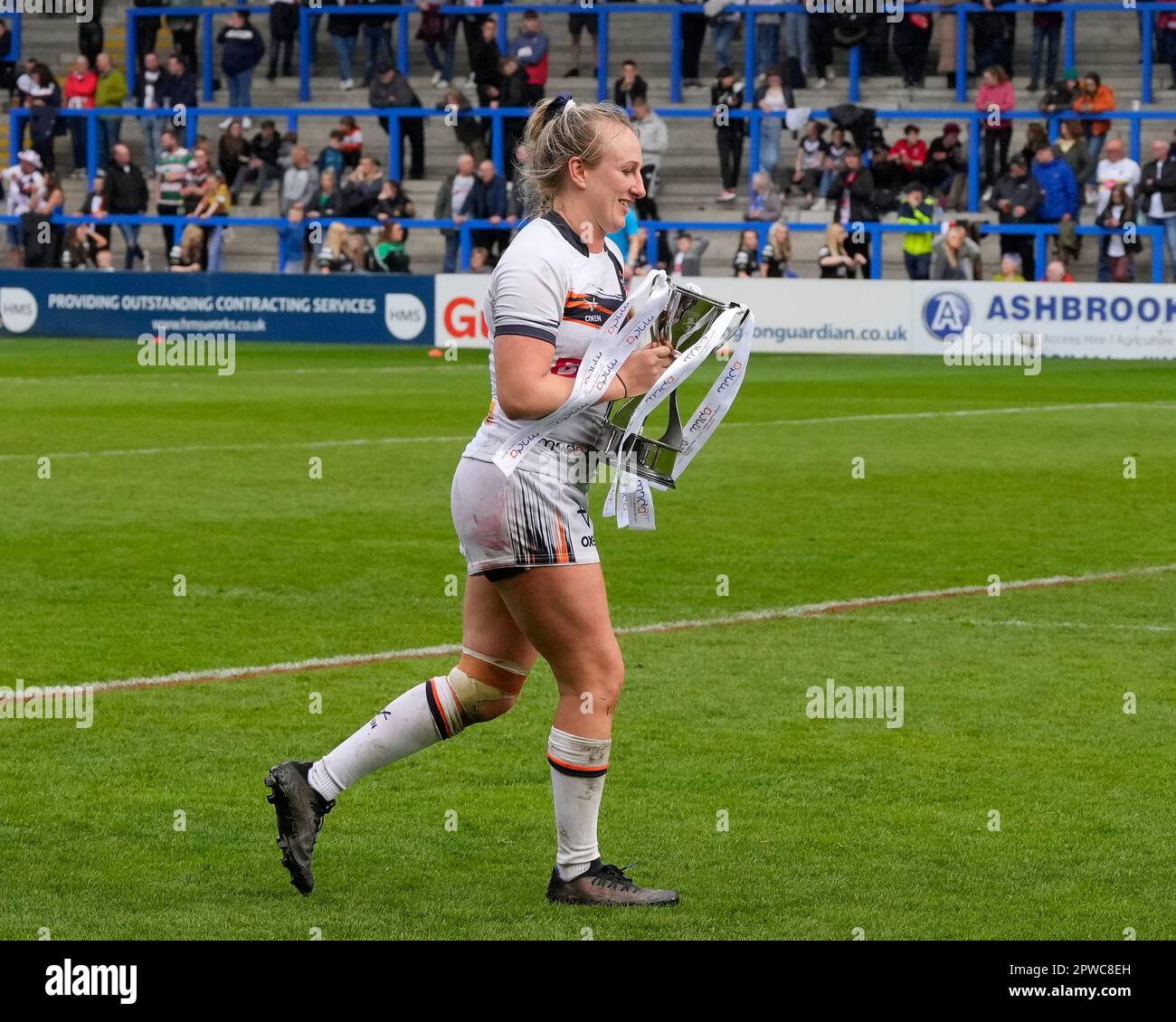 Jodie Cunningham #13 of England carries the trophy to her team mates ...