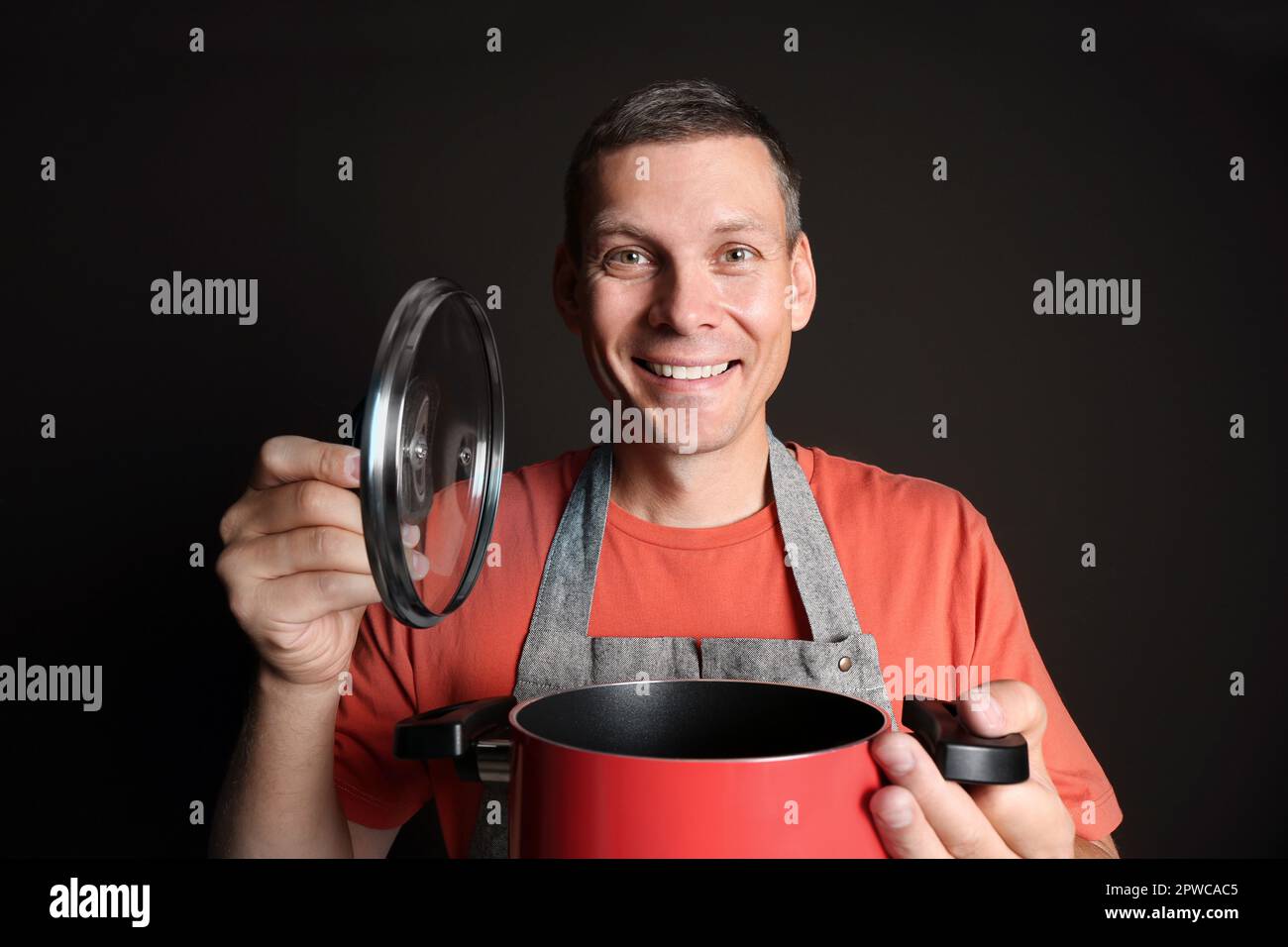 Happy man cooking pot hi-res stock photography and images - Alamy