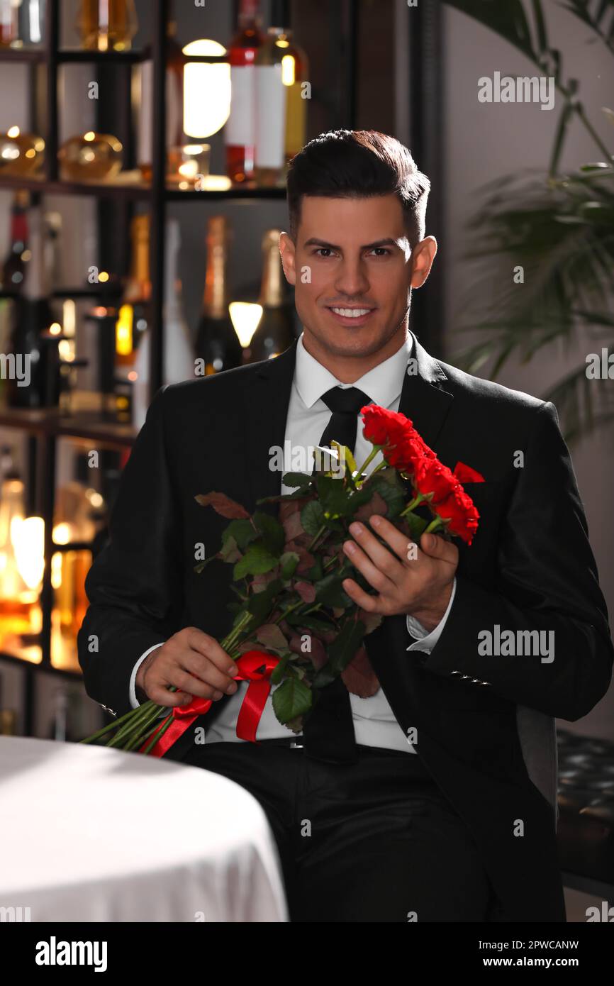 Smiling handsome man waiting girlfriend hi-res stock photography and ...