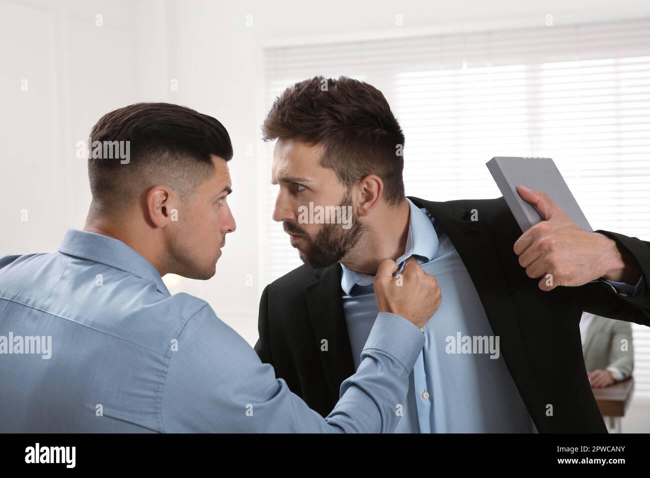 Emotional colleagues fighting in office. Workplace conflict Stock Photo ...