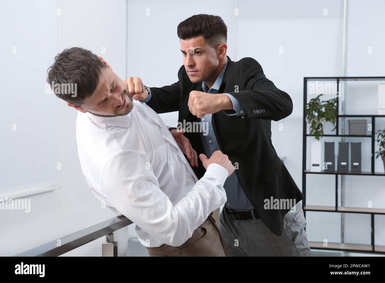 Emotional colleagues fighting in office. Workplace conflict Stock Photo ...