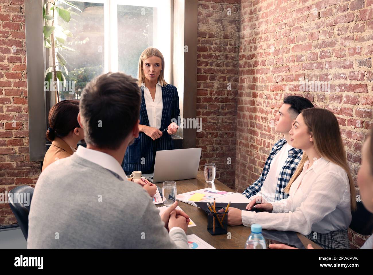 Businesswoman having meeting with her employees in office. Lady boss ...
