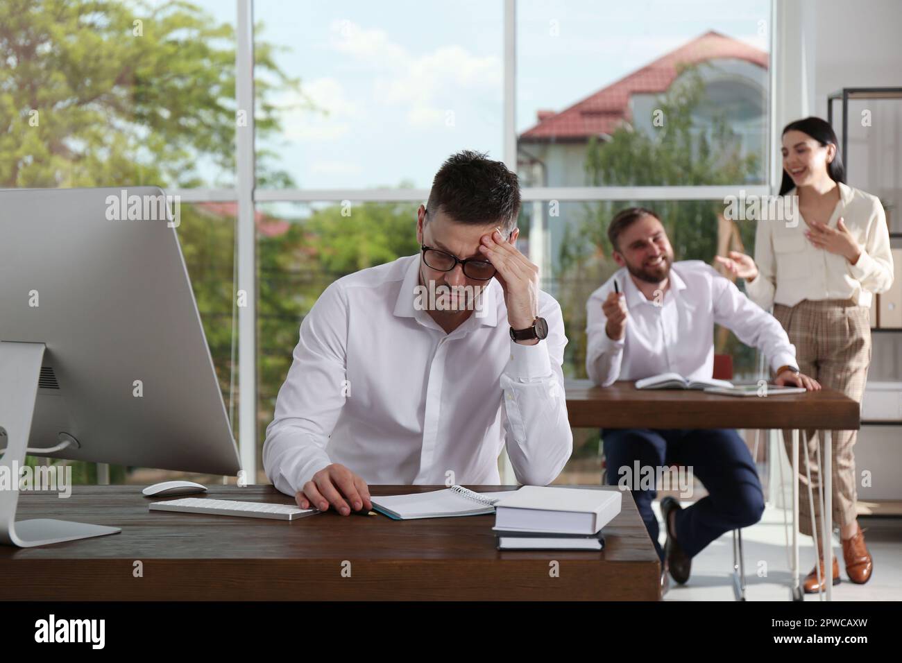Man suffering from toxic environment at work Stock Photo - Alamy