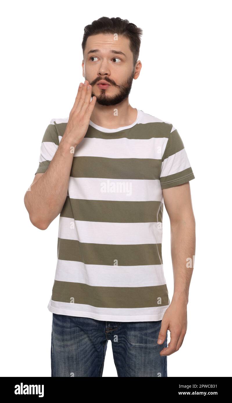 Embarrassed man covering mouth with hand on white background Stock ...