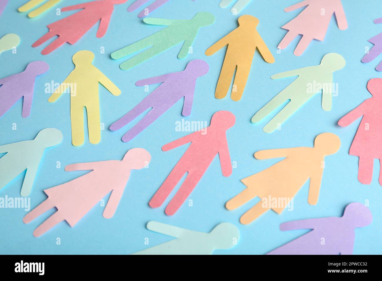 Many different paper human figures on light blue background. Diversity ... Many different paper human figures on light blue background. Diversity ...