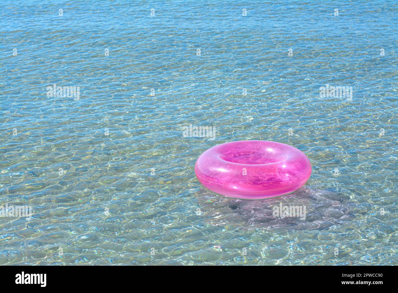 Bright inflatable ring floating on sea water. Space for text Stock ...