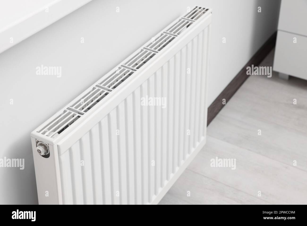 Modern radiator on white wall in room. Central heating system Stock ...