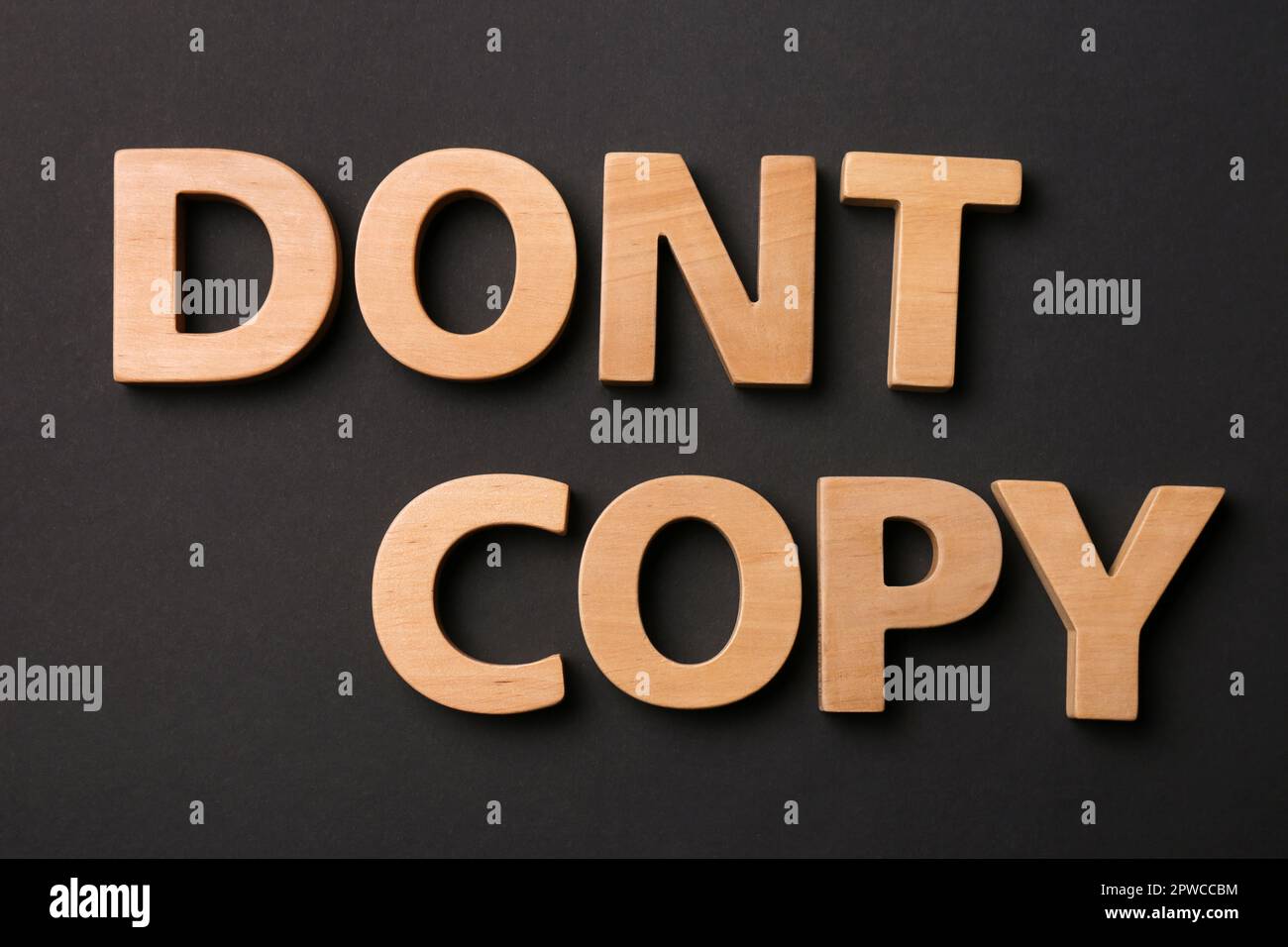 Words Don't Copy made of wooden letters on black background, flat lay ...