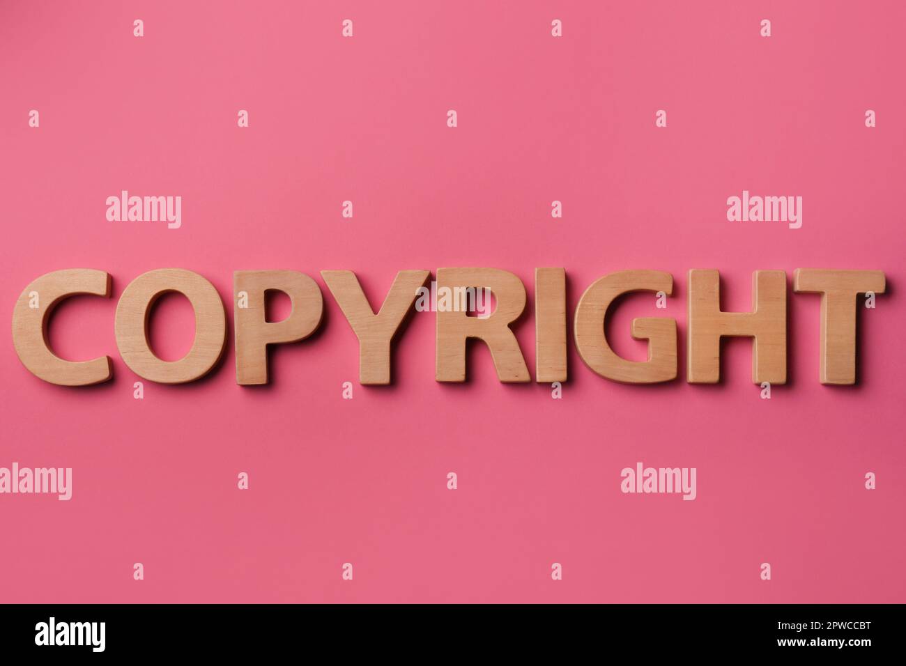 Word Copyright made of wooden letters on dark pink background, flat lay ...