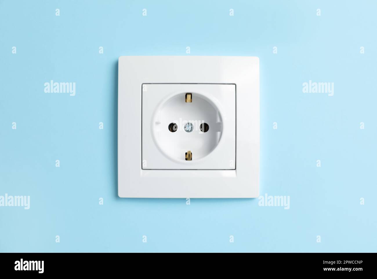 Power socket on light blue wall. Electrical supply Stock Photo - Alamy