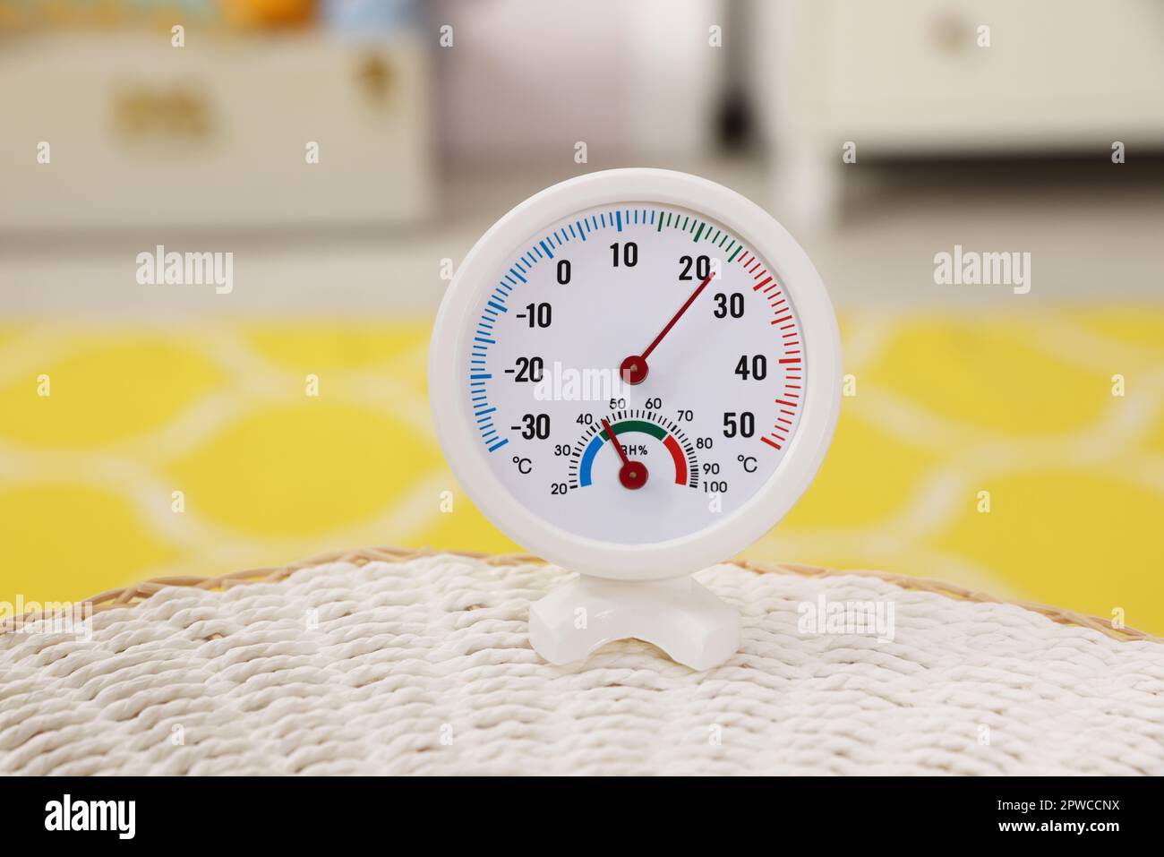 Round hygrometer with thermometer on mat in room Stock Photo - Alamy