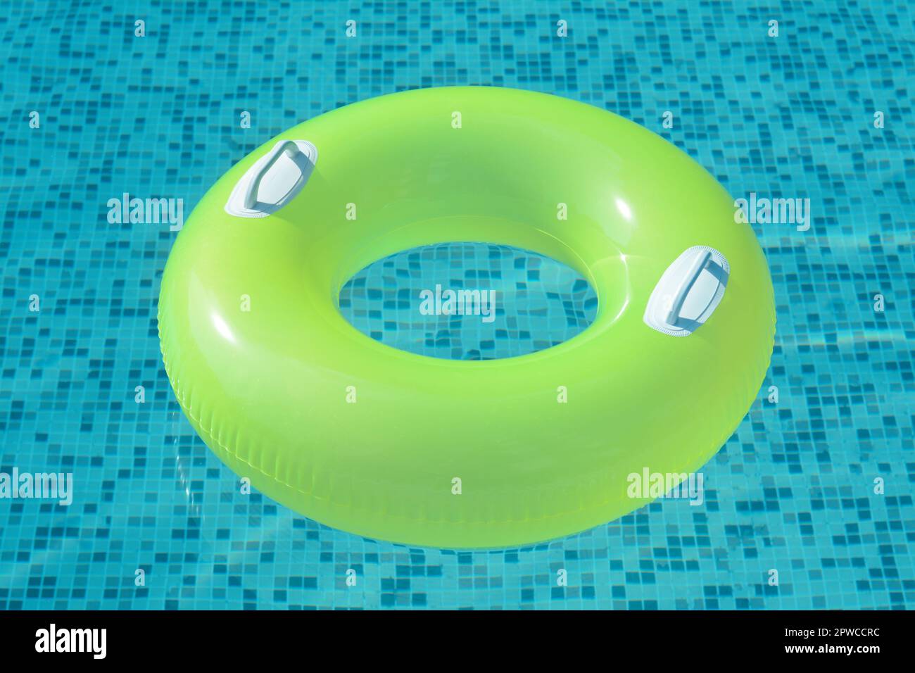 Light green inflatable ring floating in swimming pool Stock Photo - Alamy