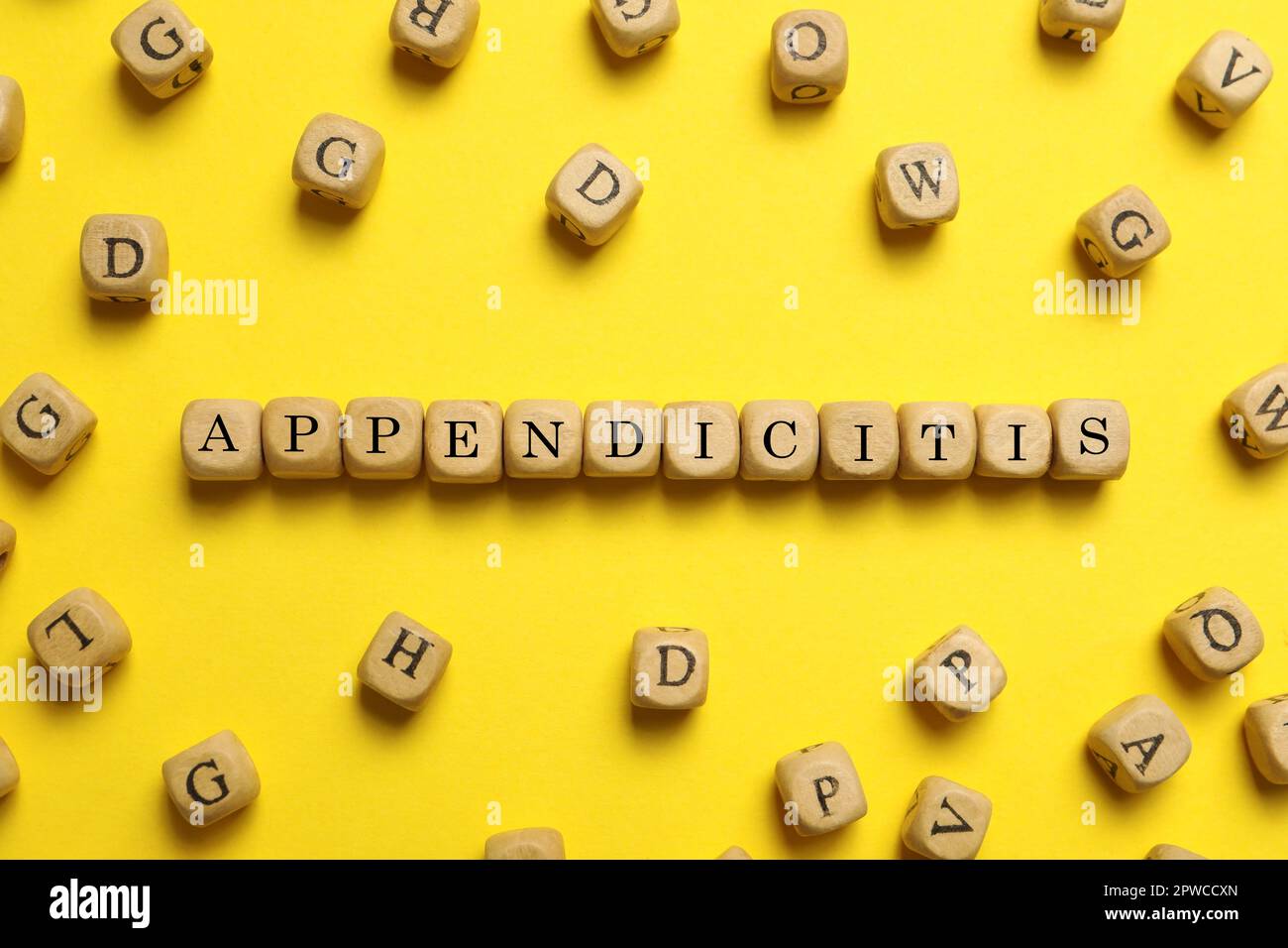 Word Appendicitis made of wooden cubes with letters on yellow ...