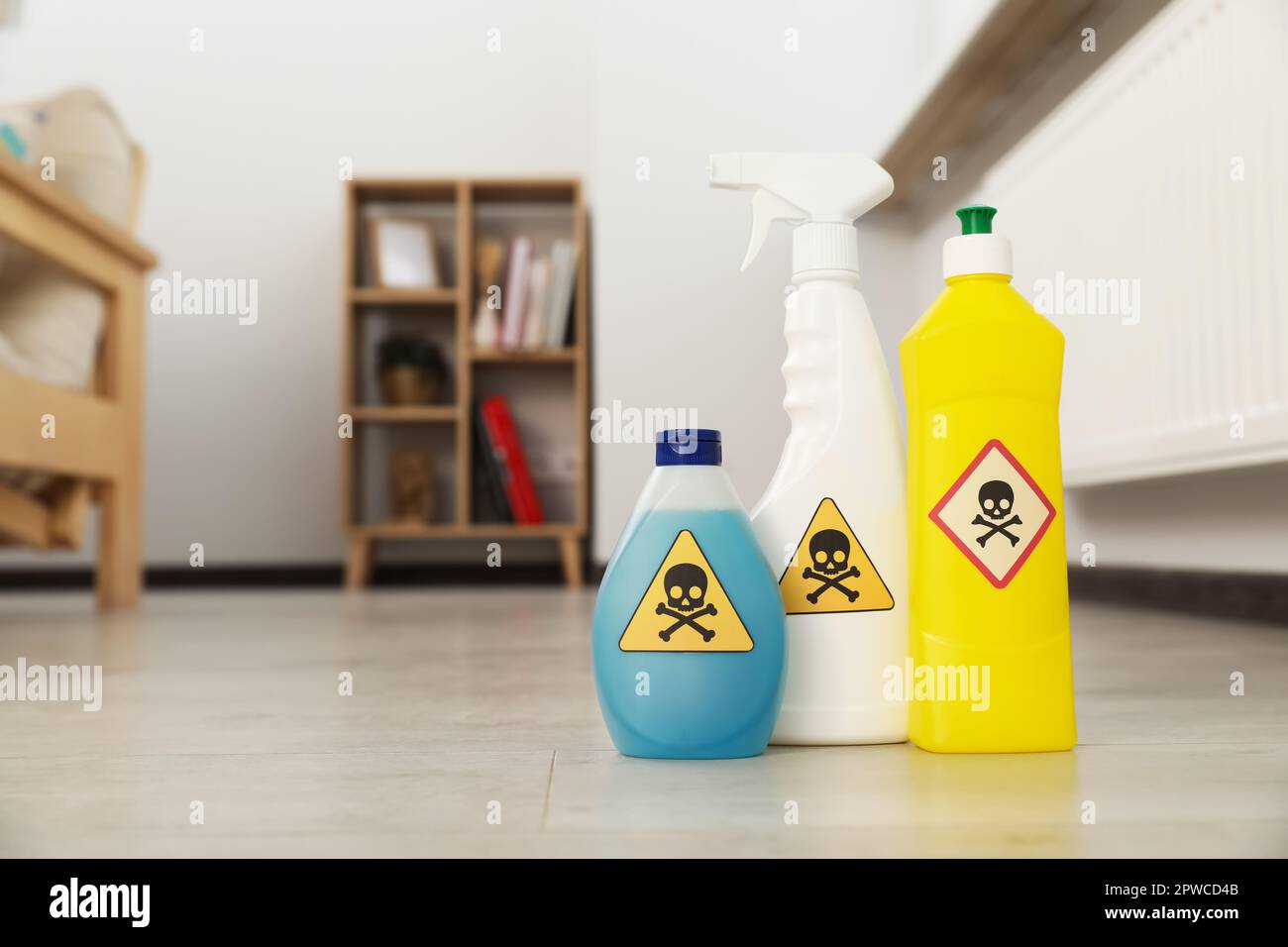 Bottles of toxic household chemicals with warning signs in room, space ...