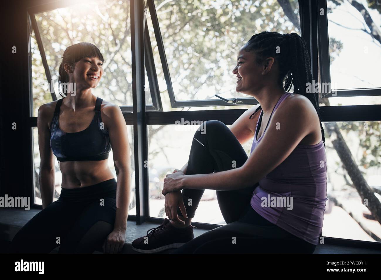 We enjoy coming to the gym together. two friends chatting while out for ...