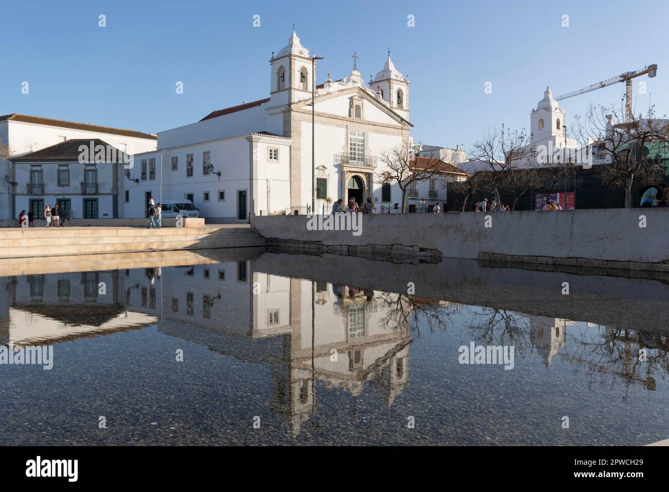 Igreja de Santa Maria de Lagos with water reflection in a fountain on ...