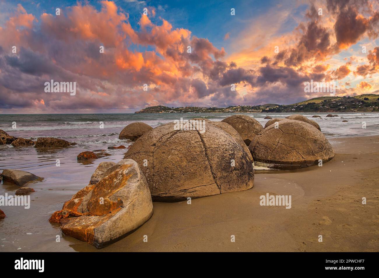 Moeraki Boulders, rock boulders on sandy beach at sunrise, geological ...
